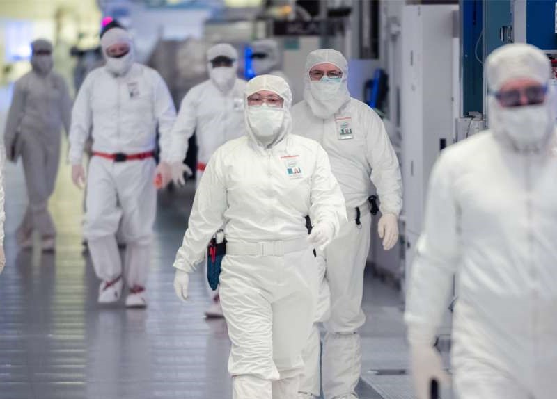 Manufacturing employees wearing a bunny suit
